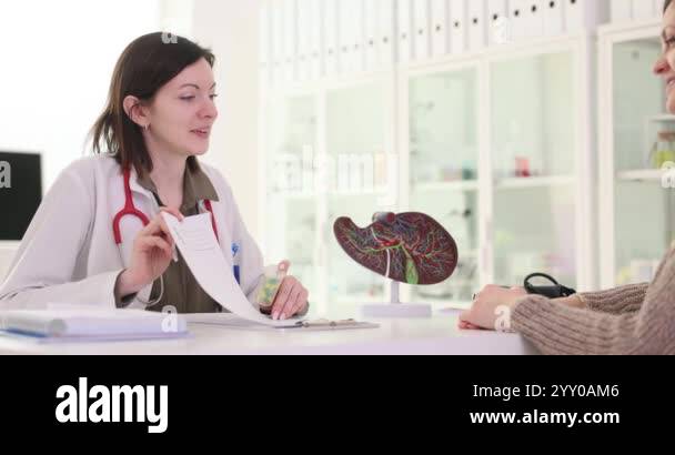 Woman doctor with medical test results provides treatment to female ...