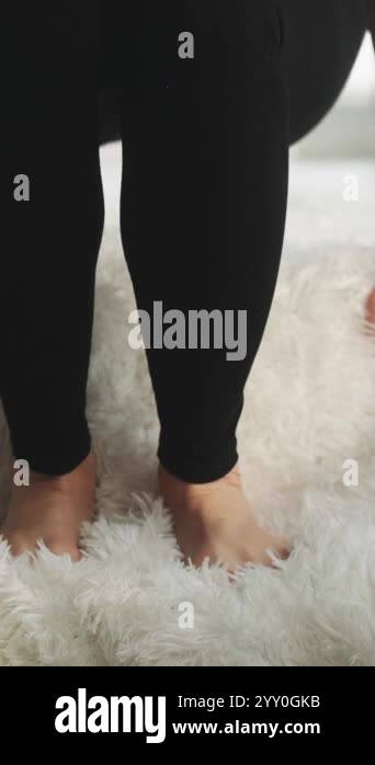 Vertical video. Flat feet. Sore legs. Foot massage. Woman rubbing tired ...