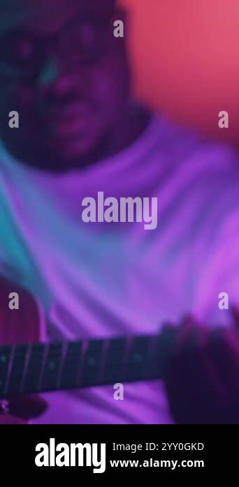 Vertical video. Music performance. Guitar club. Inspired man playing ...