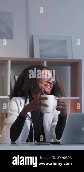 Vertical video. Doctor relaxing. Work break. Happy peaceful woman ...