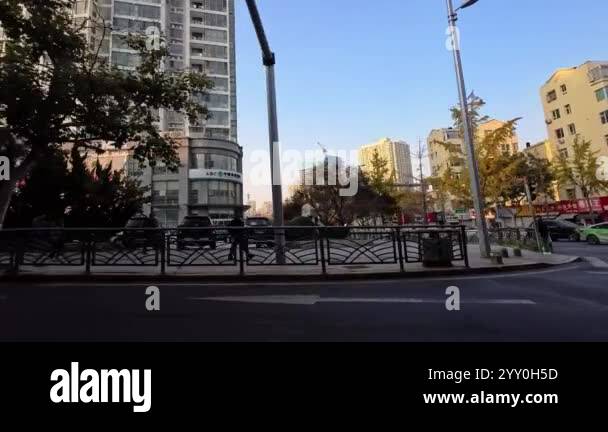 Busy streets of a modern city show pedestrians walking alongside cars ...