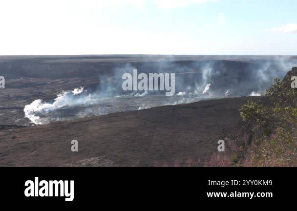 Wide steady shot of steam rising out of Klauea volcano several days ...