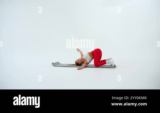 Young woman curling up on a white background Stock Video Footage - Alamy