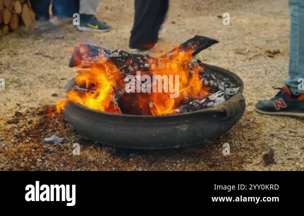 Process of burning wood in bowl to produce charcoal. Fire acts on ...