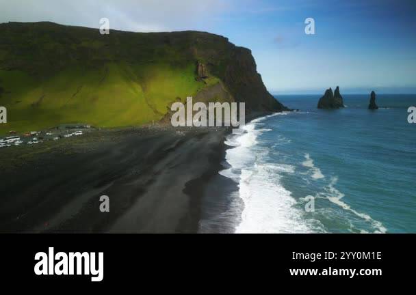 Calm foaming ocean waves roll onto shore with cliff aerial view ...