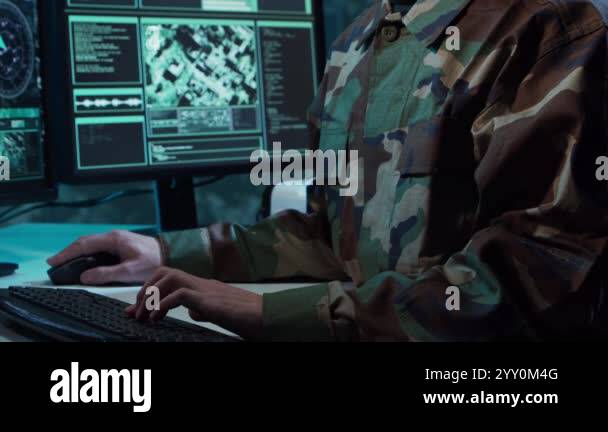 Dramatic scene of a soldier in a dimly lit military control room ...