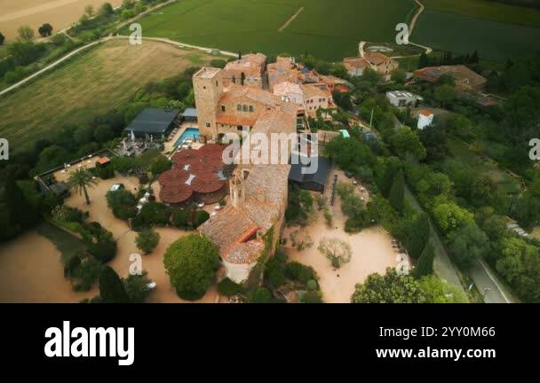 Hotel Castell d Emporda with church and patio among farm fields aerial ...