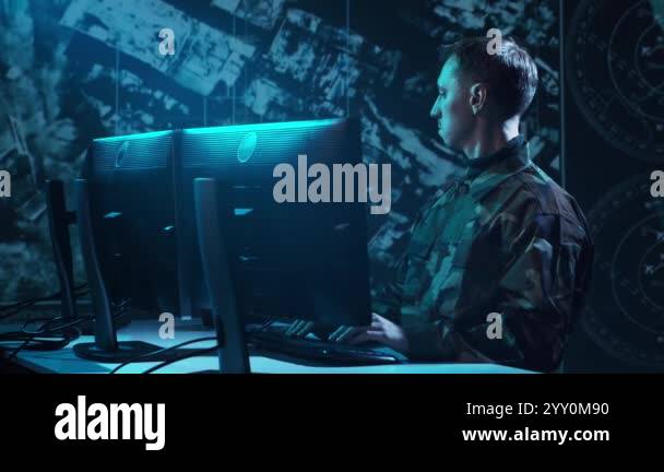 Dramatic scene of a soldier in a dimly lit military control room ...