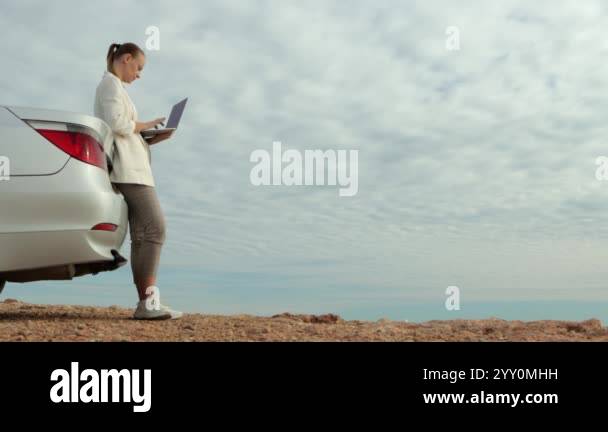 young female driver in casual wear using laptop while driving car Stock ...