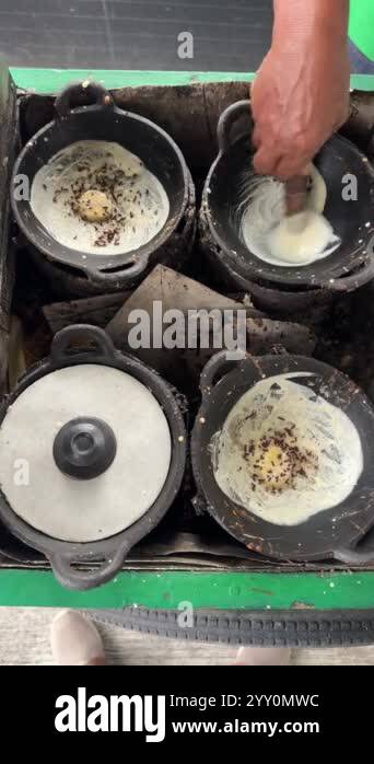 Footage of a person cooking Leker or Lekker on a mini wok pan, a ...