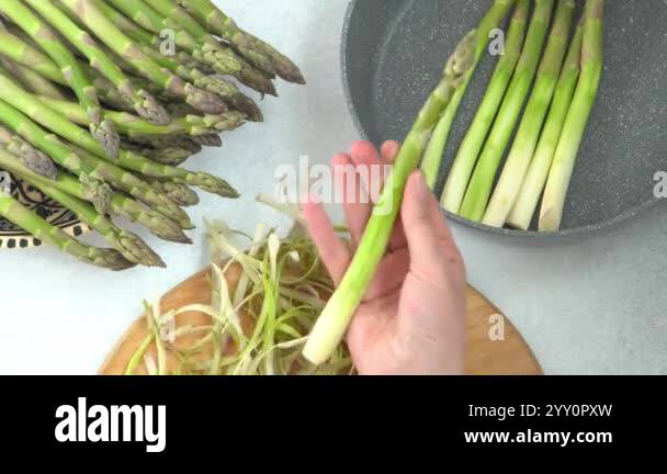 Cook asparagus. Peel and fry green sprouts. Vegetable healthy food ...
