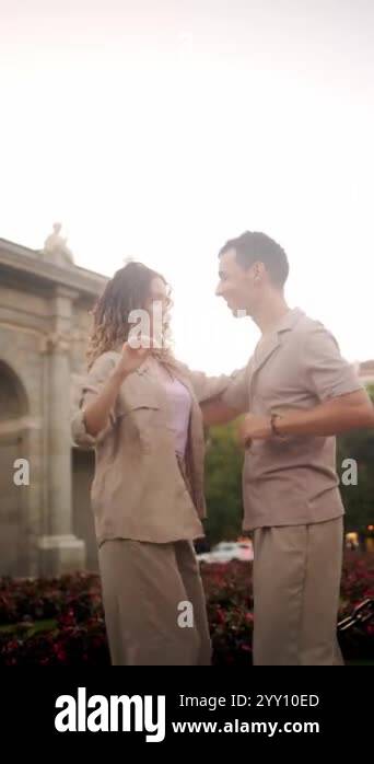 Two dancers in matching outfits are gracefully moving together ...