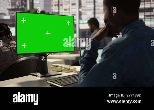 Male administrator focused on financial planning next to chroma key ...