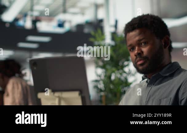 Professional black director leading a video conference with his staff ...
