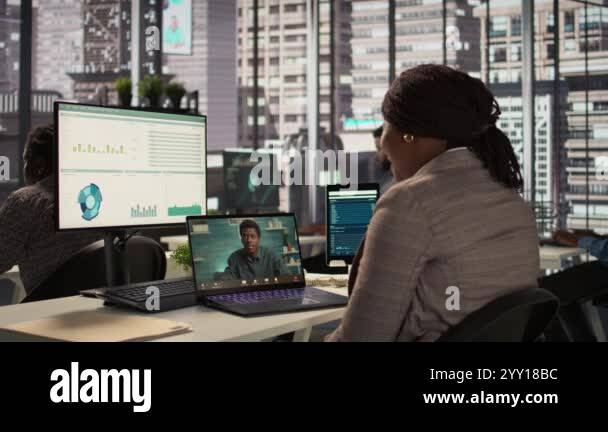 Black director discuss on a video call with business consultant for a new strategy, uses remote ...