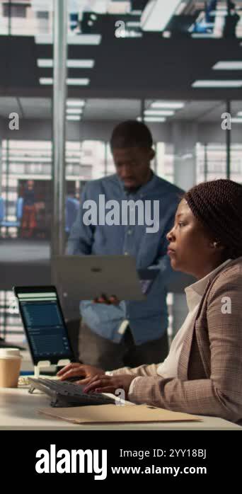 Vertical Video Team of business associates discuss about a project ...