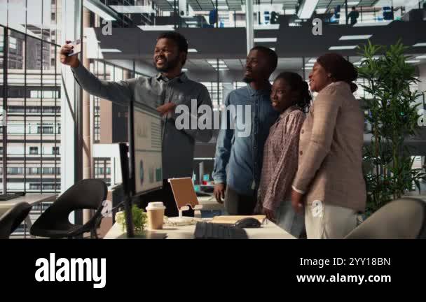 African american team members take pictures at the office on a work ...