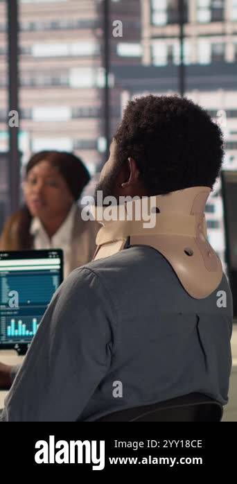 Vertical Video Black businessman struggles to work at the desk with a ...