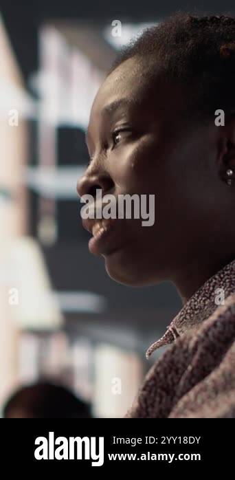 Vertical Video Executive assistant in high end office works on ...