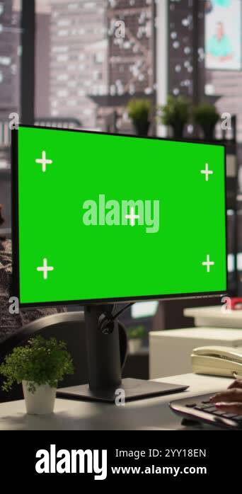 Vertical Video Businesswoman at office desk looks at green screen on ...