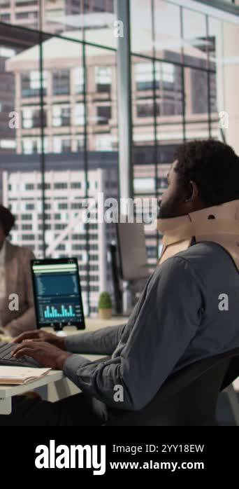 Vertical Video Black businessman struggles to work at the desk with a ...