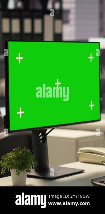 Vertical Video Businesswoman at office desk looks at green screen on ...