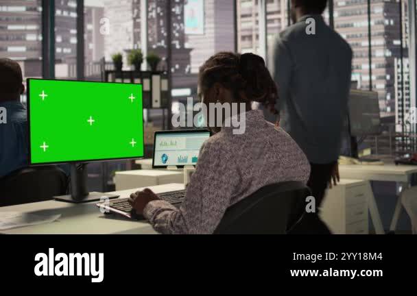 Female analyst reviewing business data on pc next to copy space screen ...