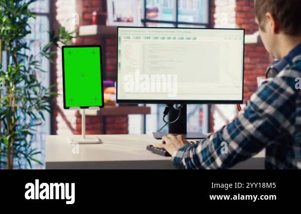 Programmer At Desk Typing Code Into Computer Developing Software Programs Consulting Green