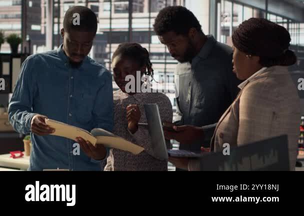 Multinational company workers meet to plan a project focused on growth ...