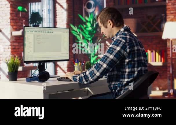 Man In Home Office Looking At Ui On Pc Screen Typing And Executing Programming Code Coding