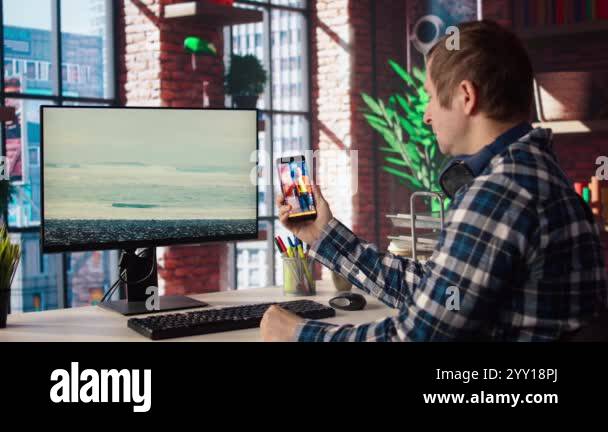Man in home office looking at social media feed with live broadcasts ...