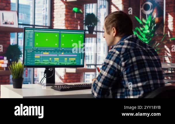 Video editor wearing headphones to polish footage and improve audio ...