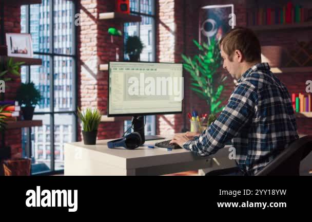 Man In Home Office Stretches Back While Looking At Ui On Pc Screen Feeling Fatigued While