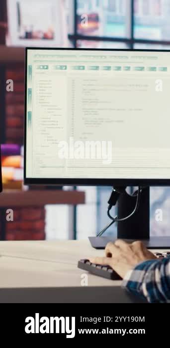 Programmer At Desk Typing Code Into Computer Developing Software
