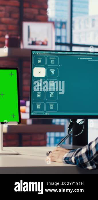 Man looking at tutorial on green screen tablet to learn how to use text ...