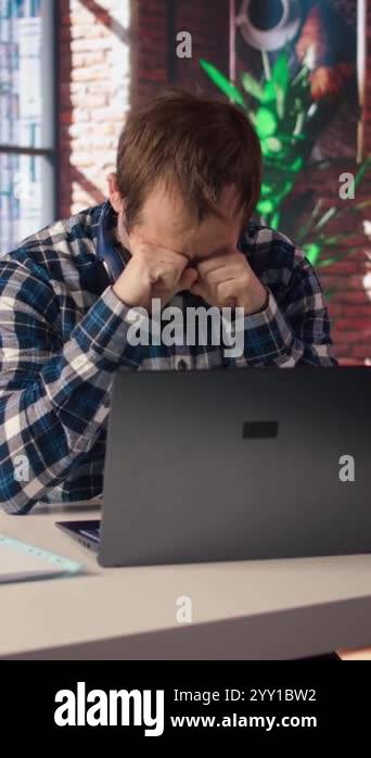 Tired man in living room office shrugging head, upset after having to ...