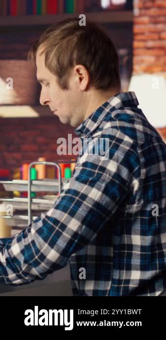 Man In Home Office Stretches Back While Looking At Ui On Pc Screen Feeling Fatigued While