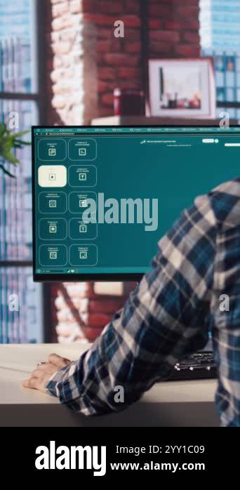 Man looking at tutorial on green screen tablet to learn how to use text ...