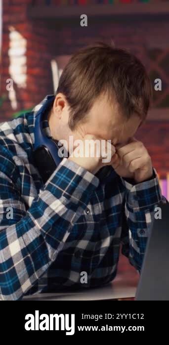 Tired man in living room home office shrugging head, upset after having ...