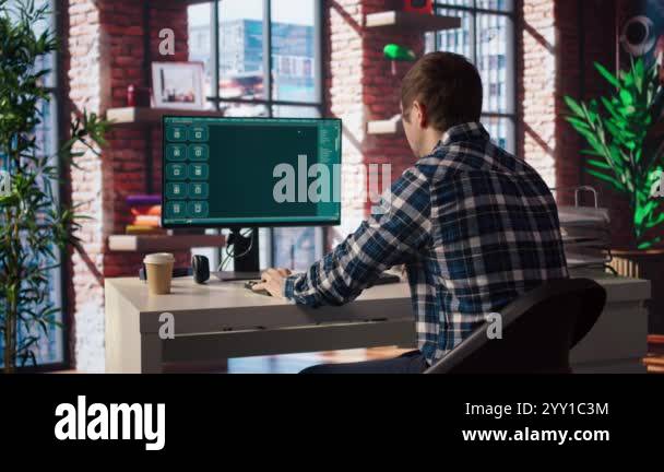 Man seated at desk using AI LLM chatbot software in modern urban home office. Person requesting ...