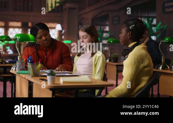 Cheerful diverse classmates sharing a high five during private lessons ...