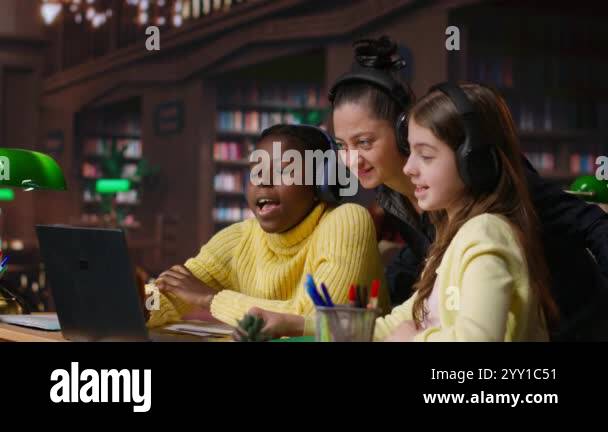 Young students and tutor attending an online class via video call in ...