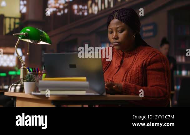 African american tutor preparing documents and learning materials for ...