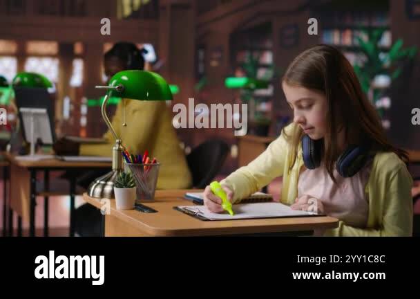 Teenager girl highlighting the important notes for the studying session ...