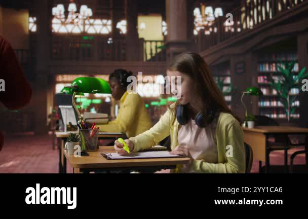 Teenager girl highlighting the important notes for the studying session ...