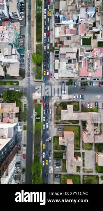 Light traffic of cars and pedestrians walking on the sidewalk at an ...