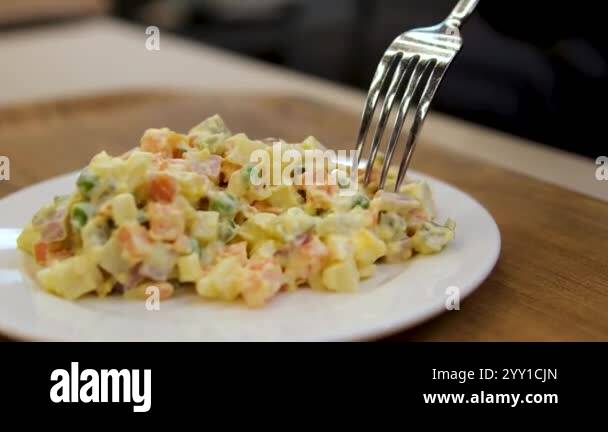 Meat salad with mayonnaise and cucumbersin a bowl. Udder salad. High ...