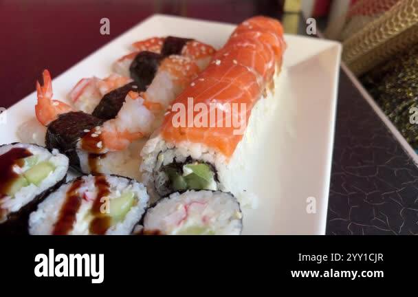 Variety of sushi rolls and nigiri on plate, traditional Japanese ...