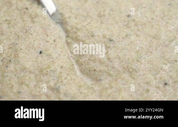 Metal spoon in thick batter made with zucchini, rice flour and psyllium ...