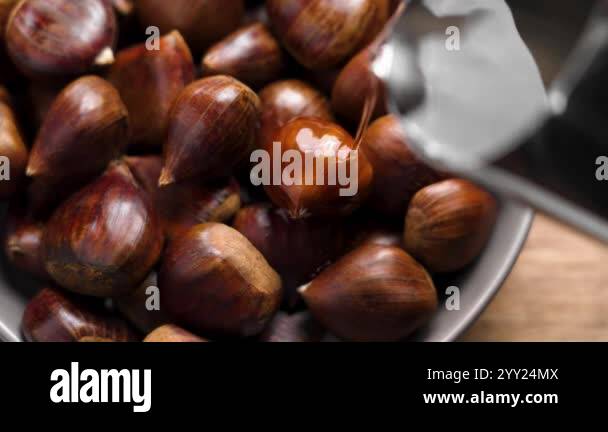 Top view of freshly harvested organic chestnuts rinsing with water from ...